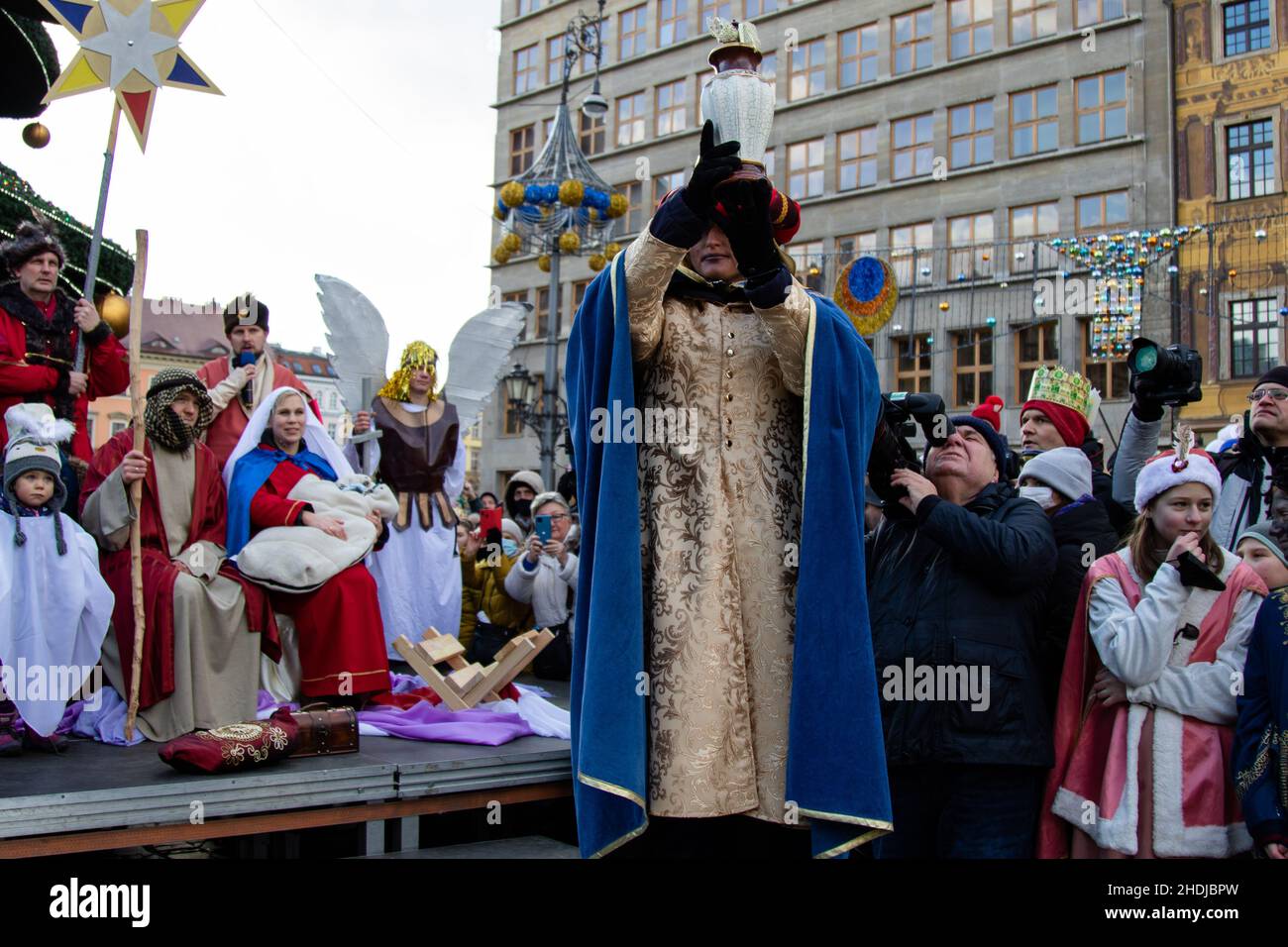 A scene of one of the wise men giving out gifts to the new born baby ...