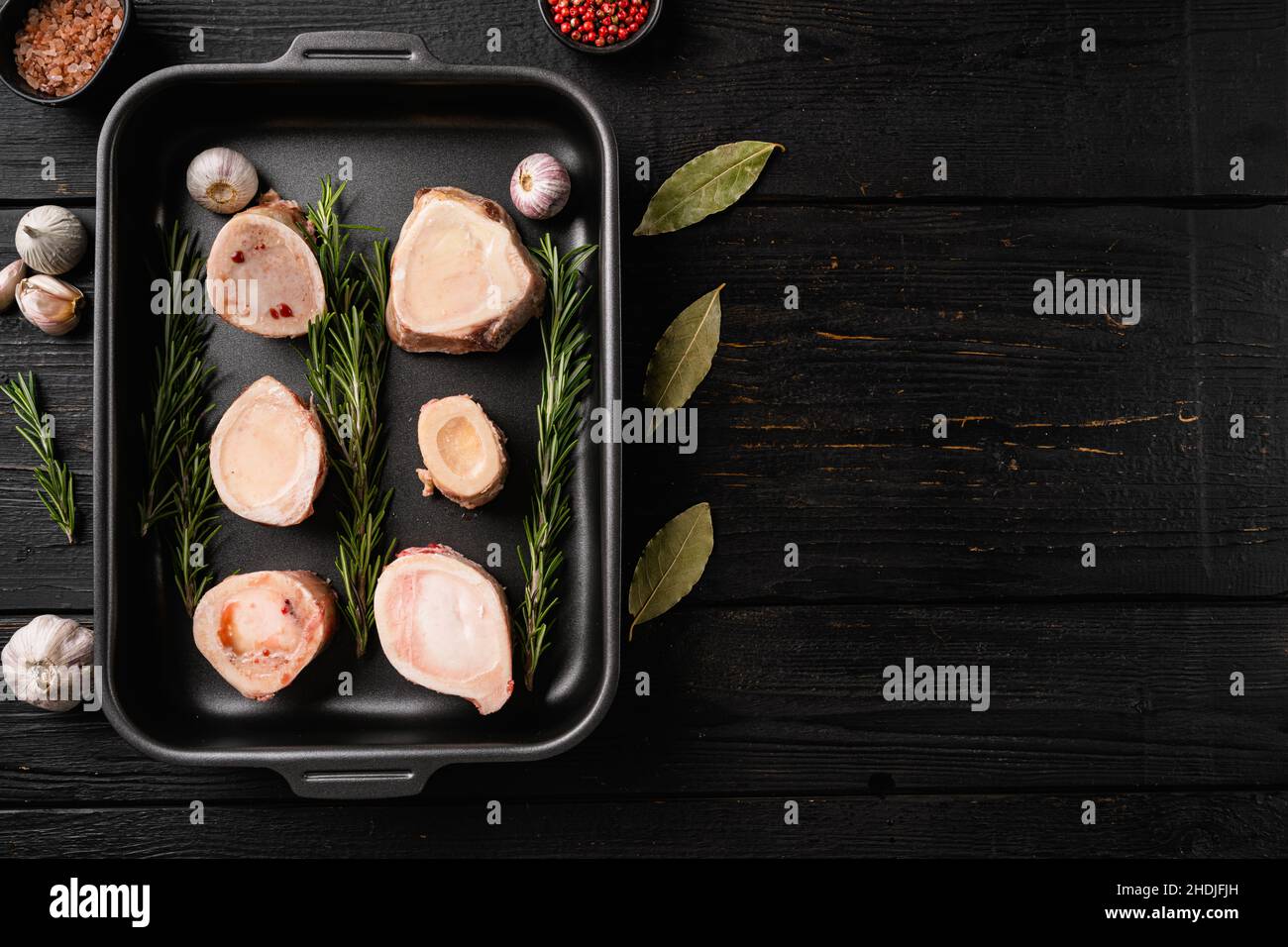 Raw calf bones set, on black wooden table background, top view flat lay ...