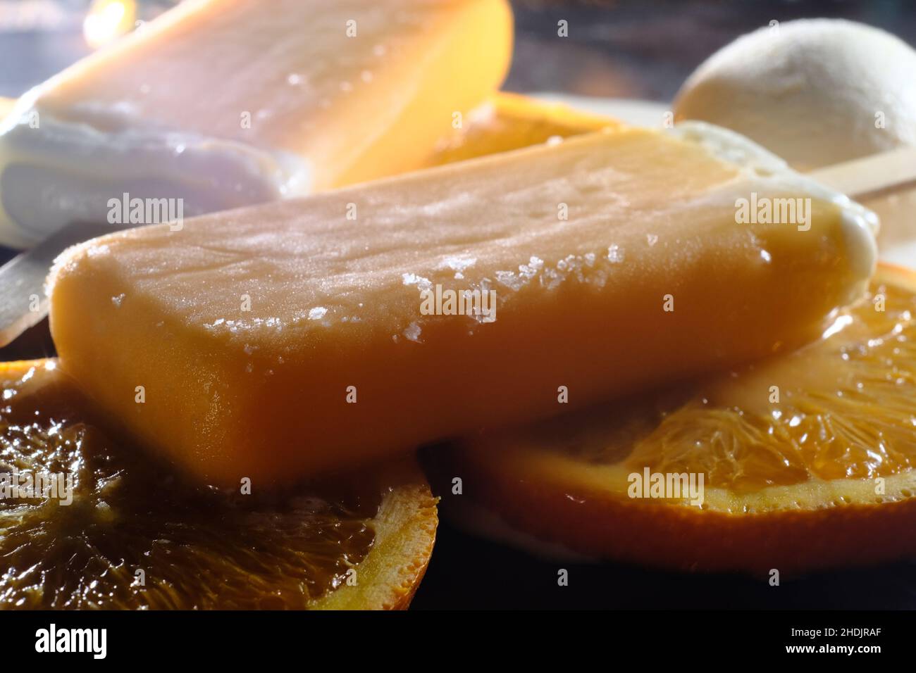 Oranges and cream vanilla ice pops melting on kitchen counter Stock ...