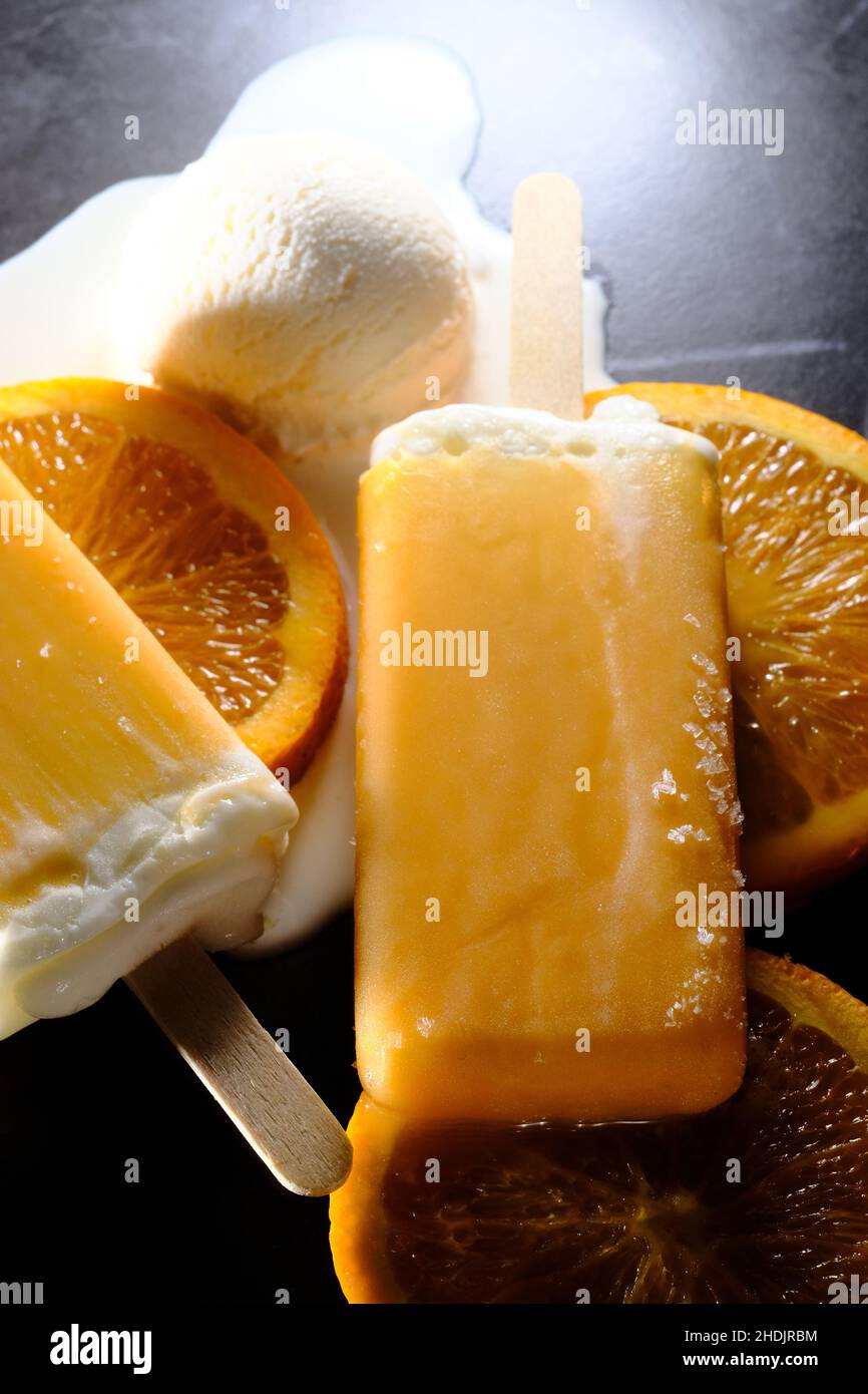 Oranges and cream vanilla ice pops melting on kitchen counter Stock ...