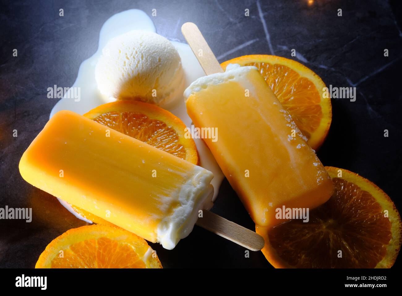 Oranges and cream vanilla ice pops melting on kitchen counter Stock ...
