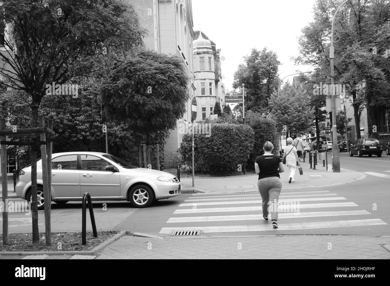 Person walking over a zebra crossing in the city center Stock Photo - Alamy