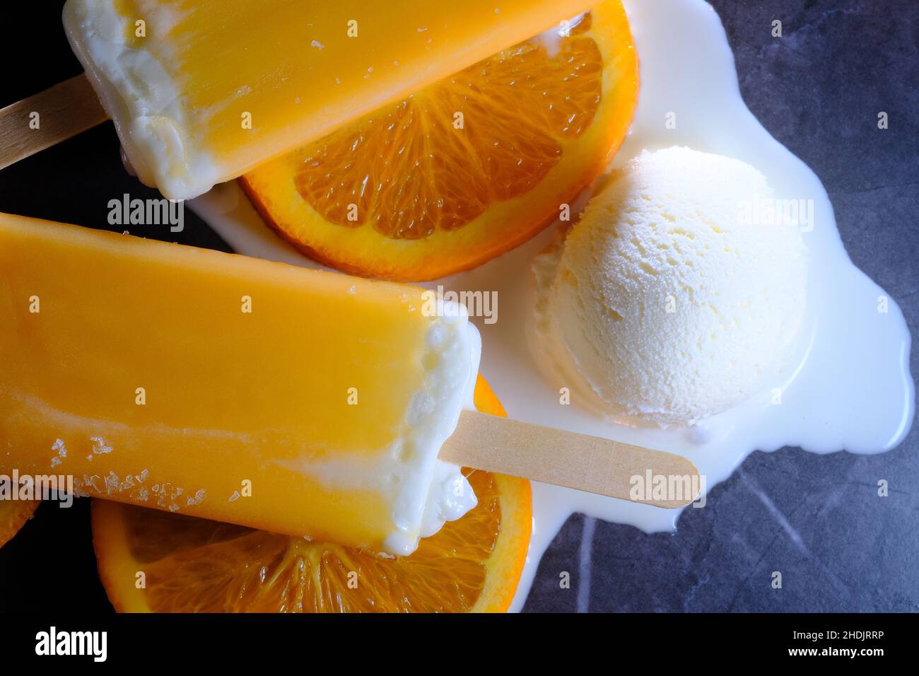 Oranges and cream vanilla ice pops melting on kitchen counter Stock ...