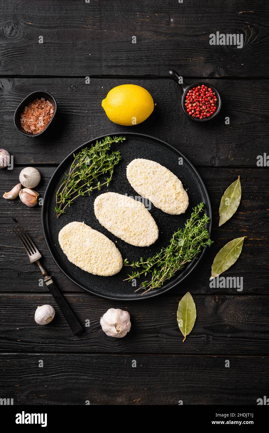 Round fresh fish cakes set, on black wooden table background, top view ...