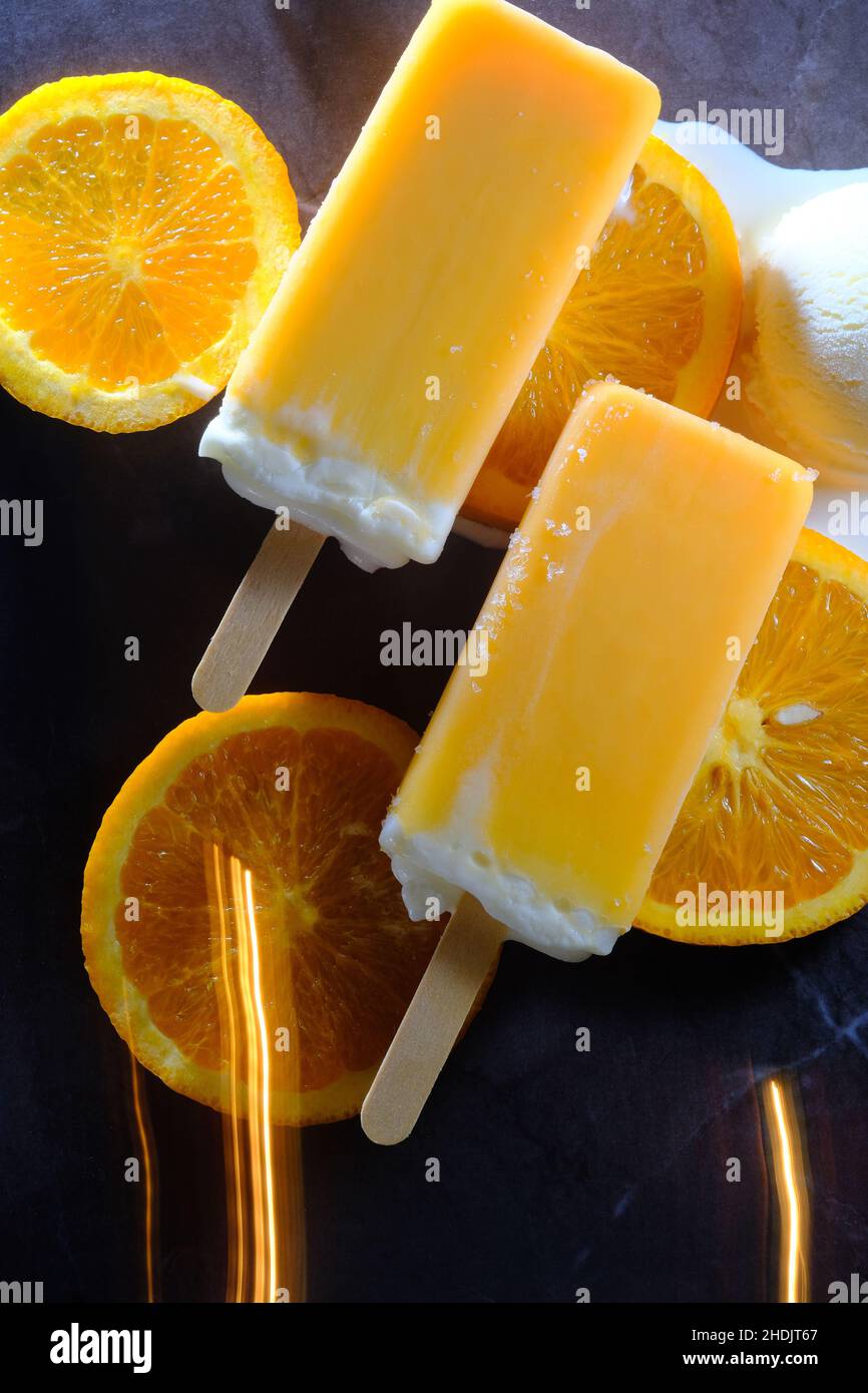 Oranges and cream vanilla ice pops melting on kitchen counter Stock ...