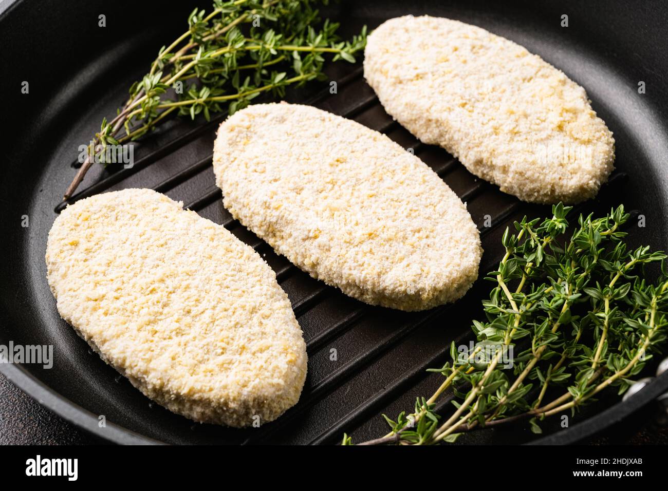 Raw breaded patty cutlets set, on old dark rustic table background ...