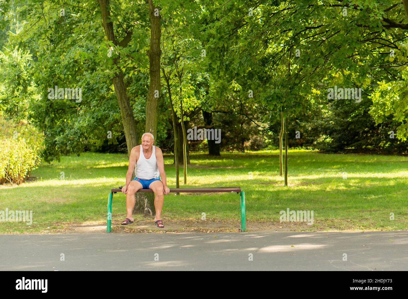 Man sitting on a bench in the Jan Pawla park Stock Photo - Alamy