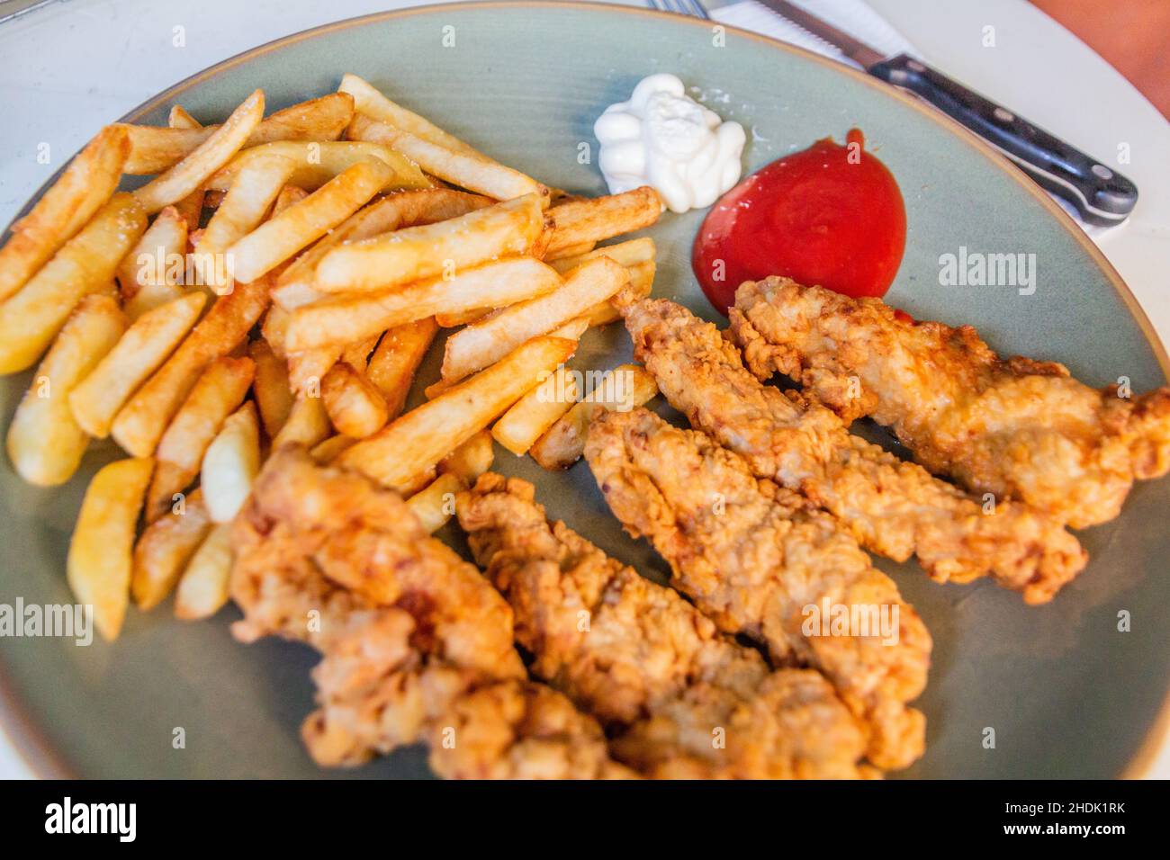 Meal in Dominican Republic. French fries with pechurina chicken strips ...