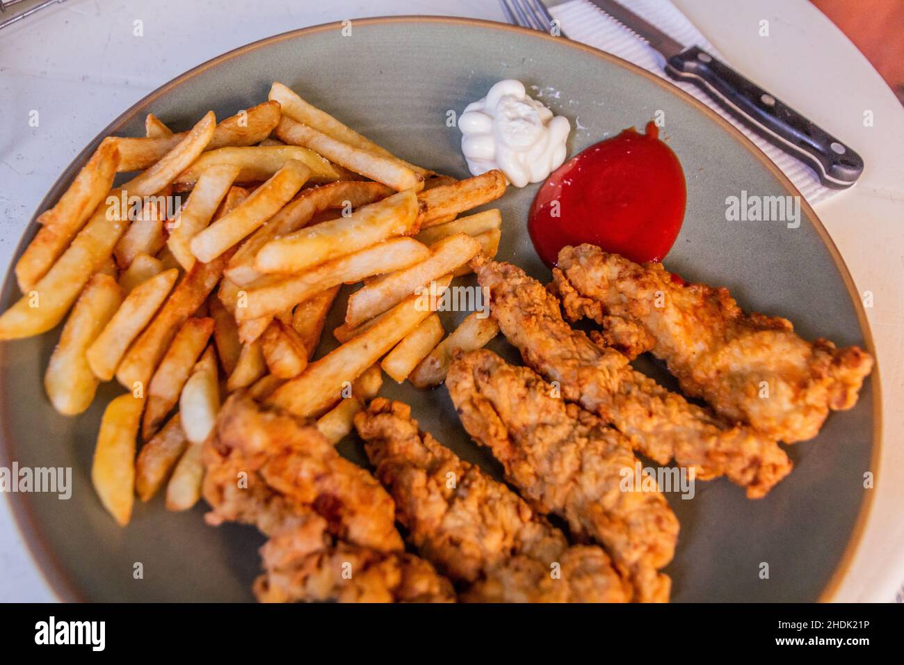 Meal in Dominican Republic. French fries with pechurina chicken strips ...