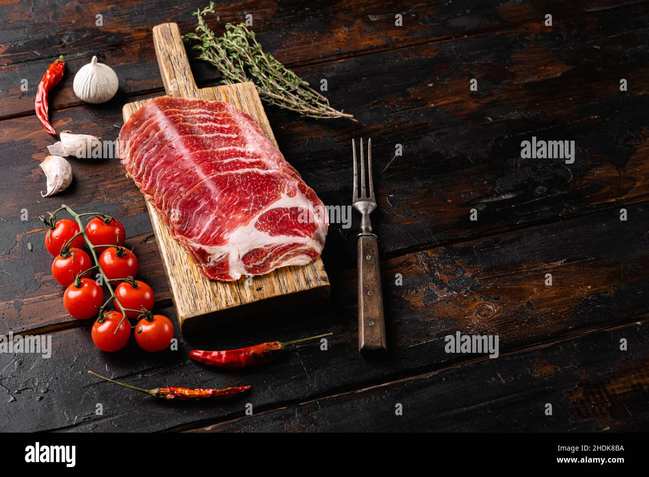 Italian sliced cured coppa with spices set, on old dark wooden table ...