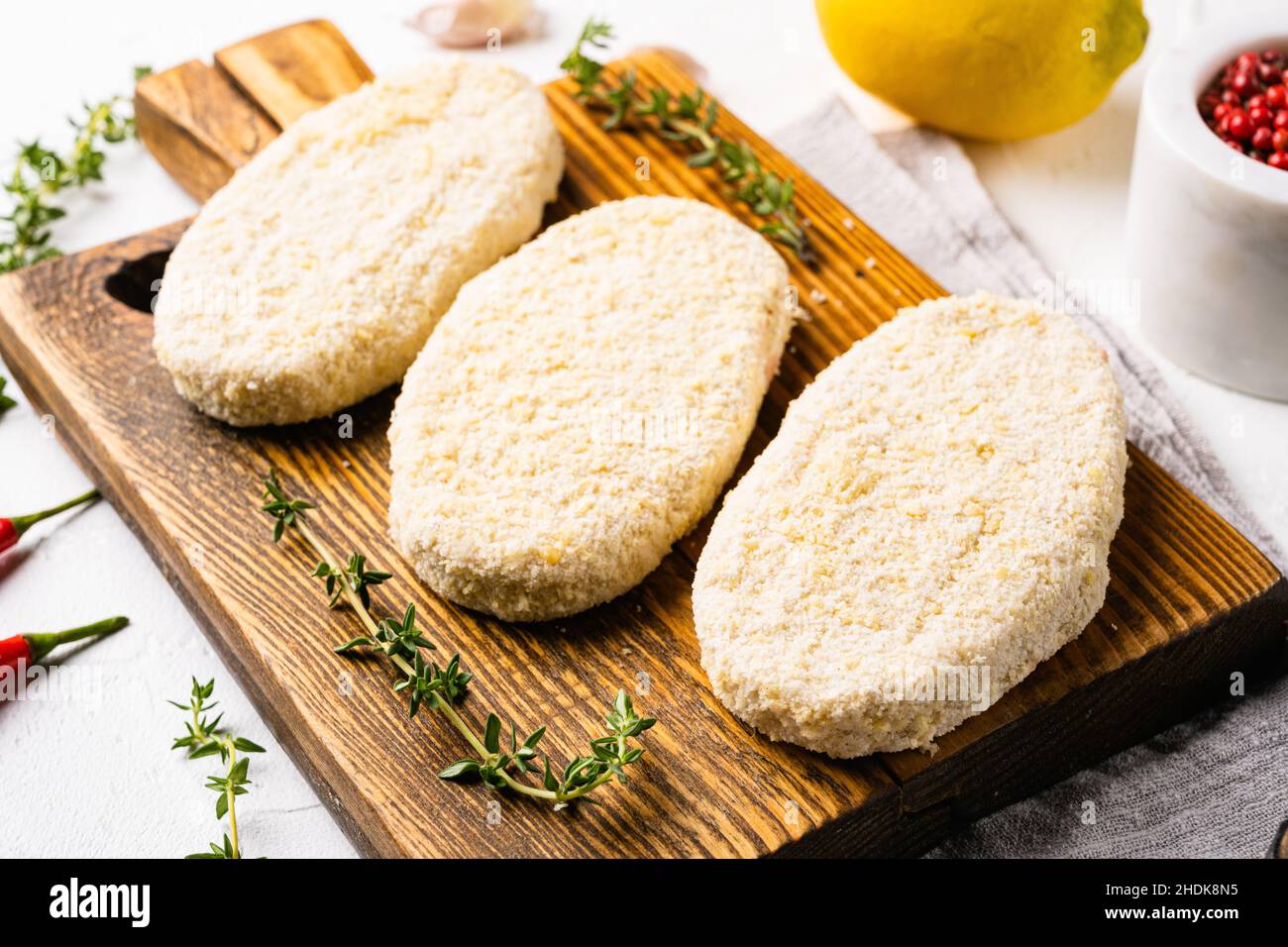 Raw breaded patty cutlets set, on white stone table background Stock ...