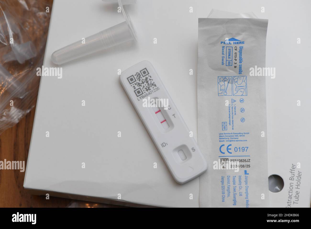 A positive Covid-19 lateral flow test held in the hand showing the two ...