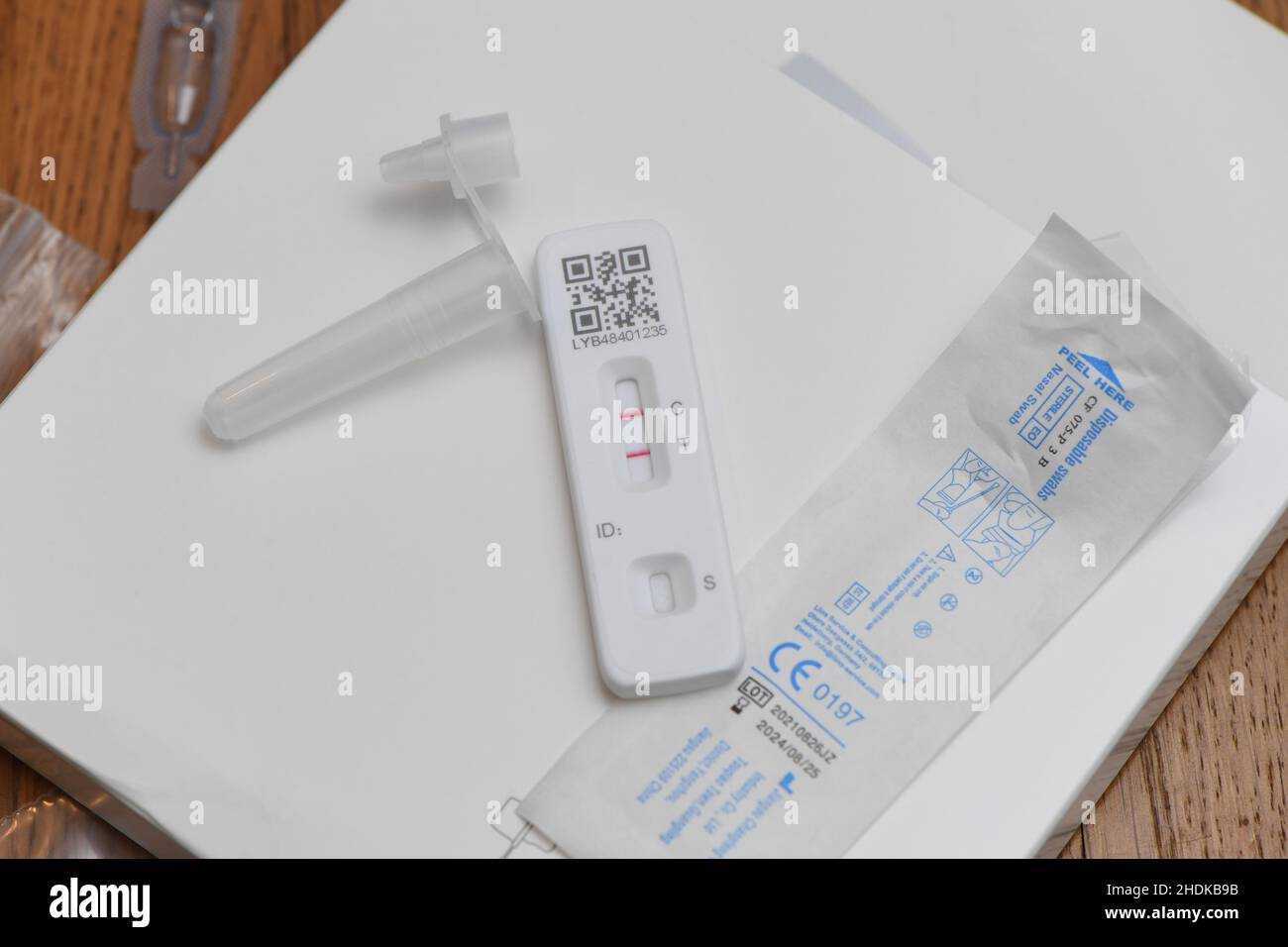 A positive Covid-19 lateral flow test held in the hand showing the two ...
