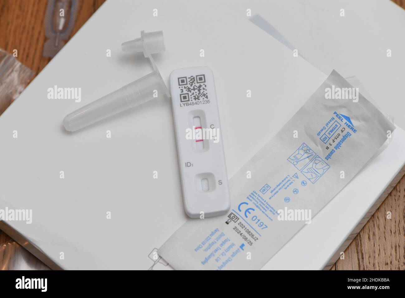 A positive Covid-19 lateral flow test held in the hand showing the two ...