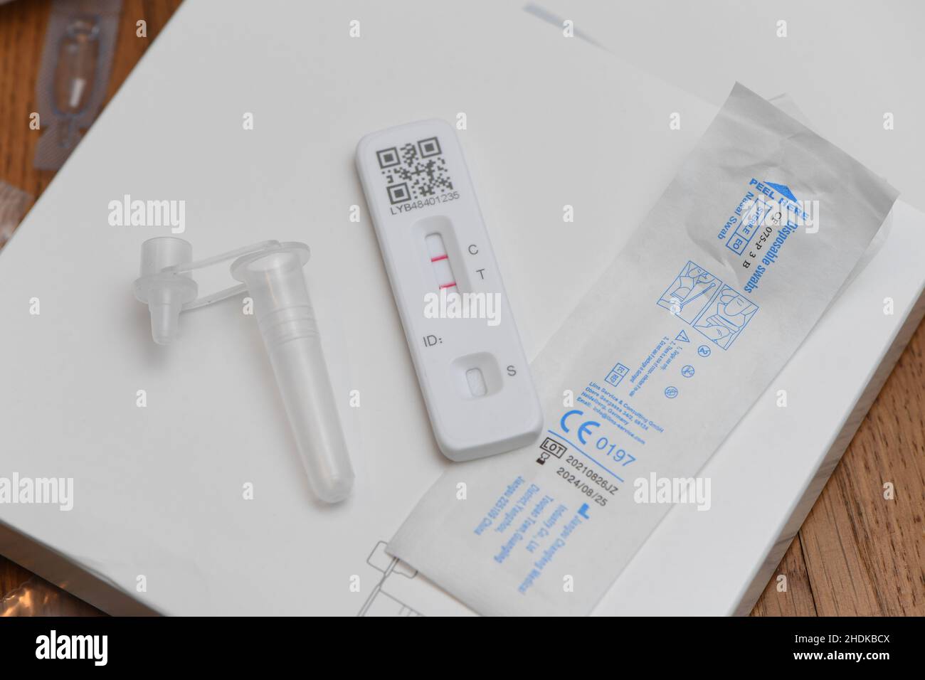 A positive Covid-19 lateral flow test held in the hand showing the two ...