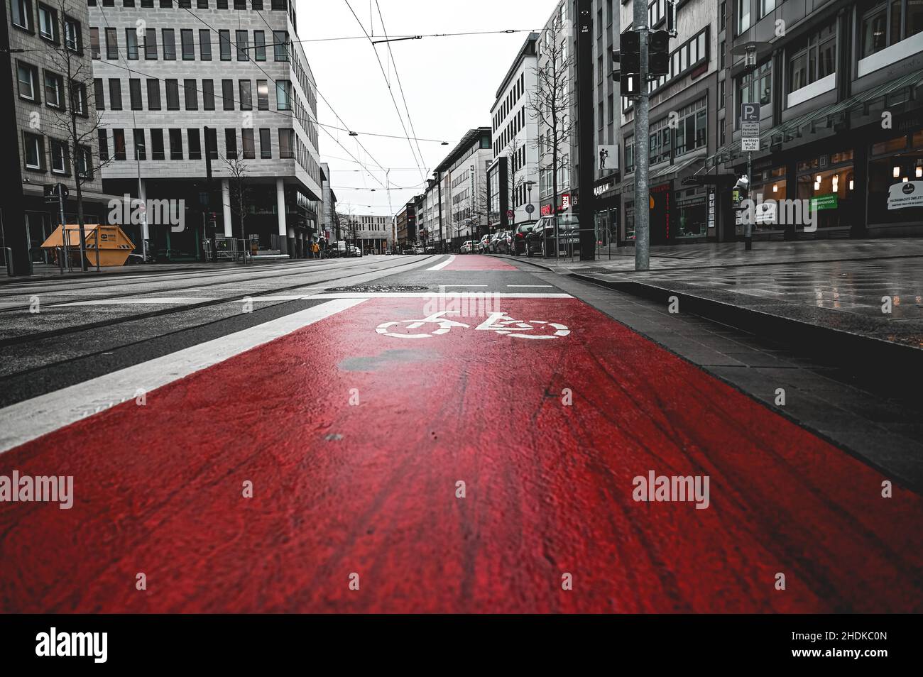 A red bicycle path with a white bicycle printed on it in Hannover at ...