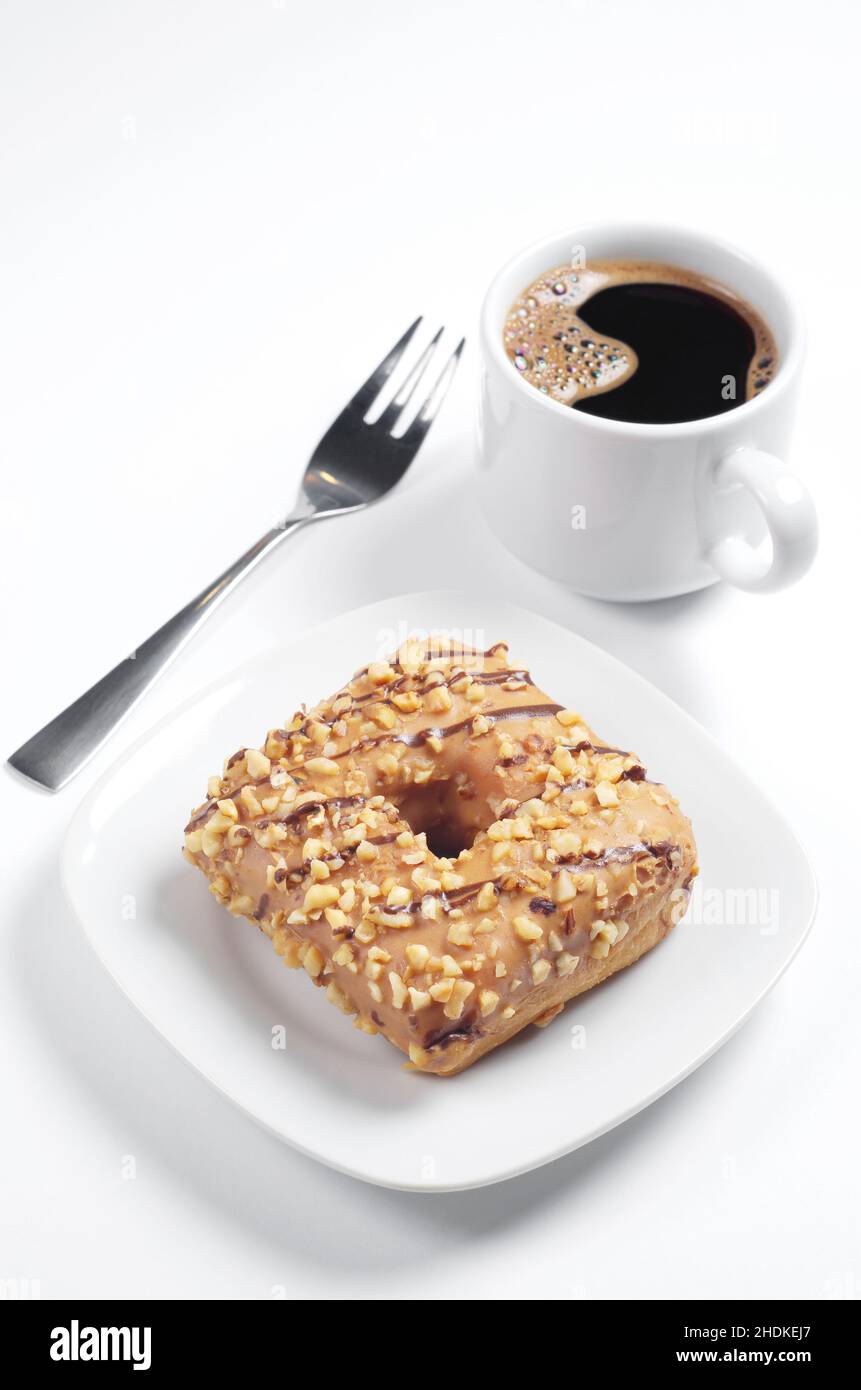 Square donut with a caramel glaze, roasted nuts and chocolate stripes ...