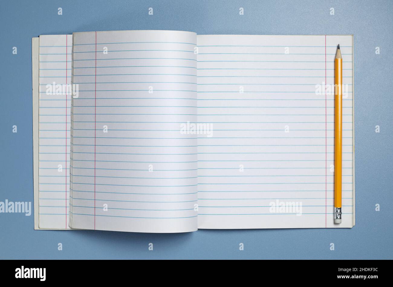 Opened school notebook and pencil on blue desk, top view Stock Photo ...