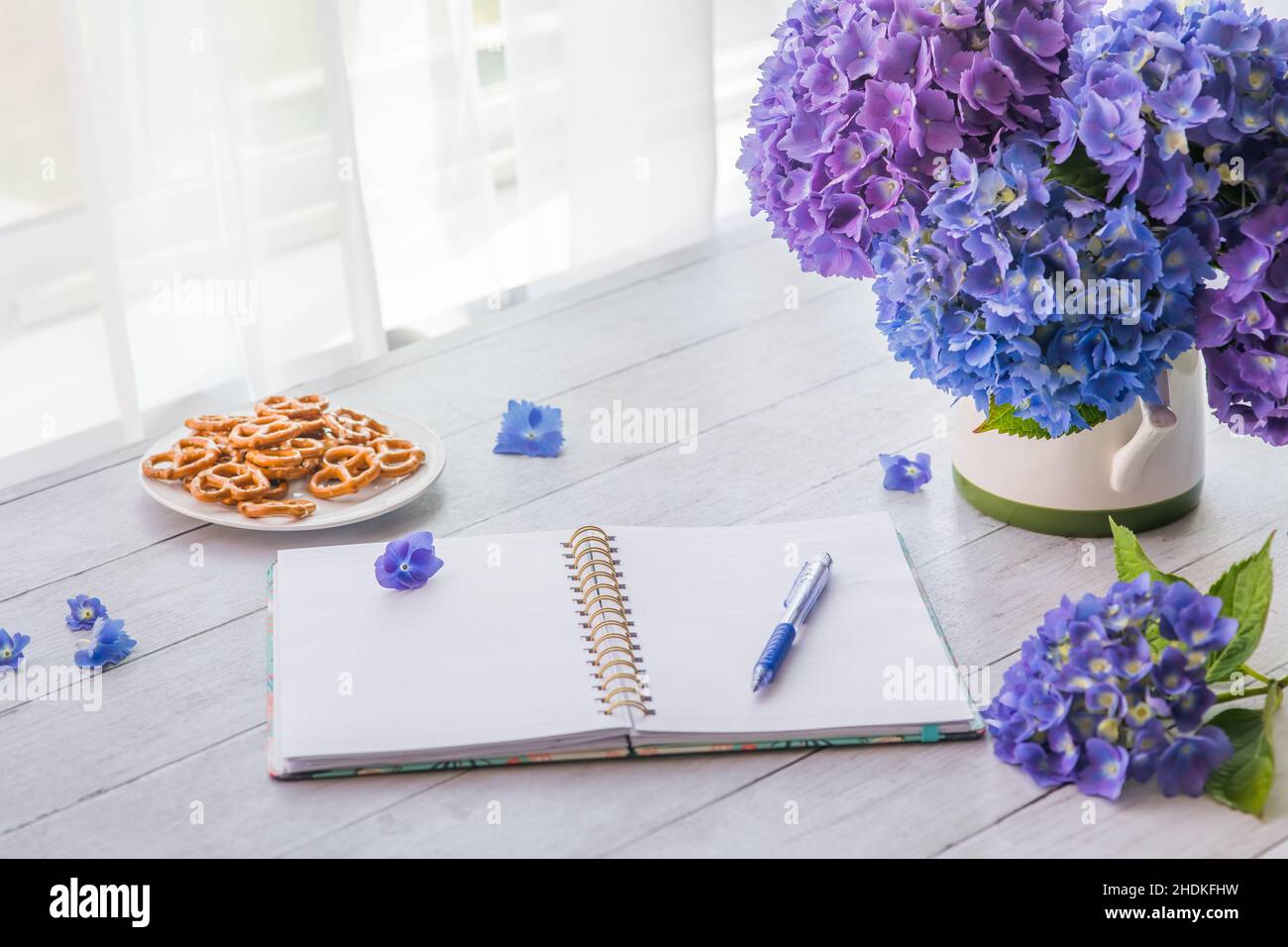 Hydrangea flowers with notebook on the table with copy space for text ...