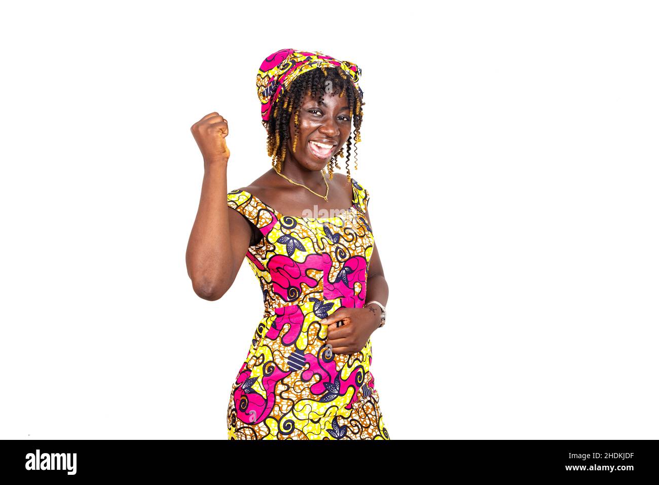 beautiful young woman making a winning gesture with raised fist and ...