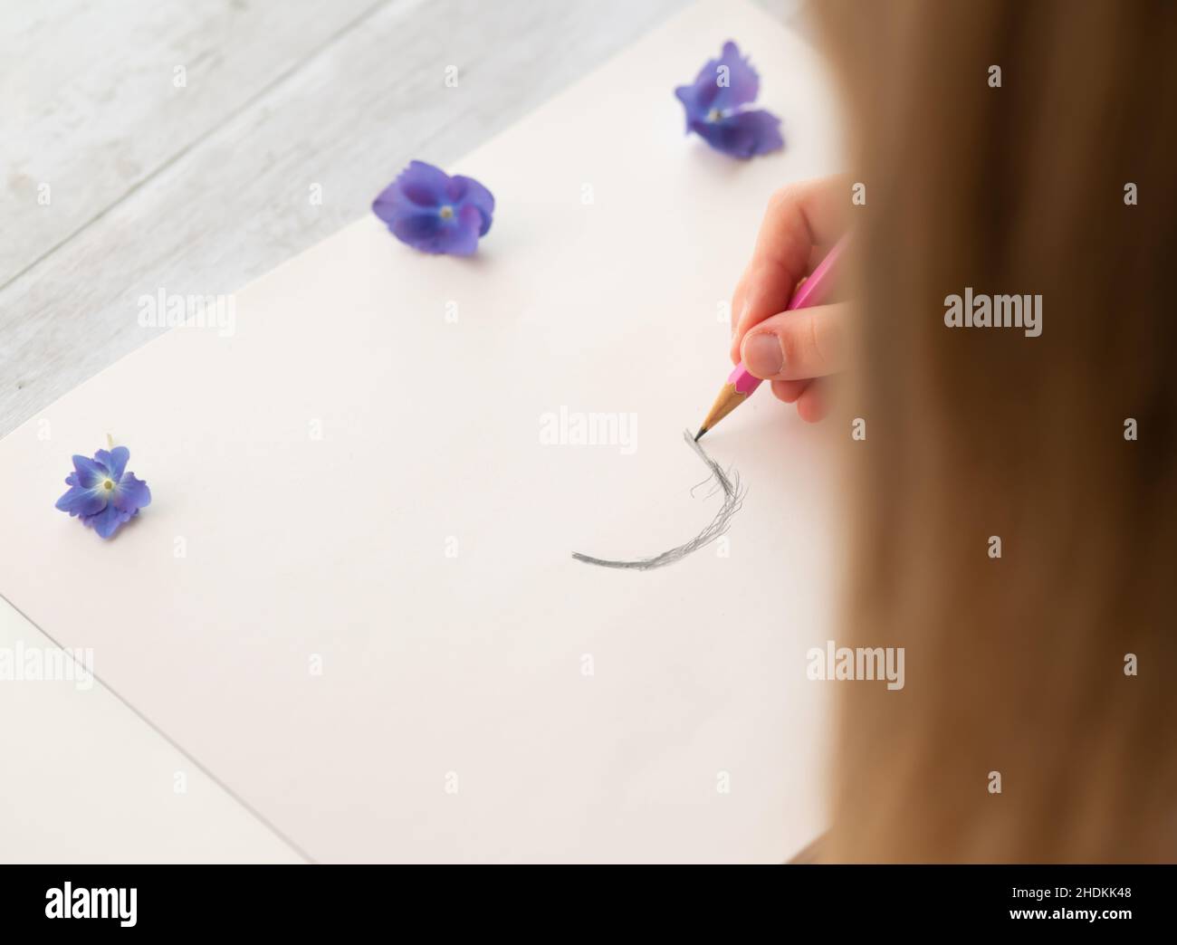 Girl drawing with pencil on a paper Stock Photo - Alamy