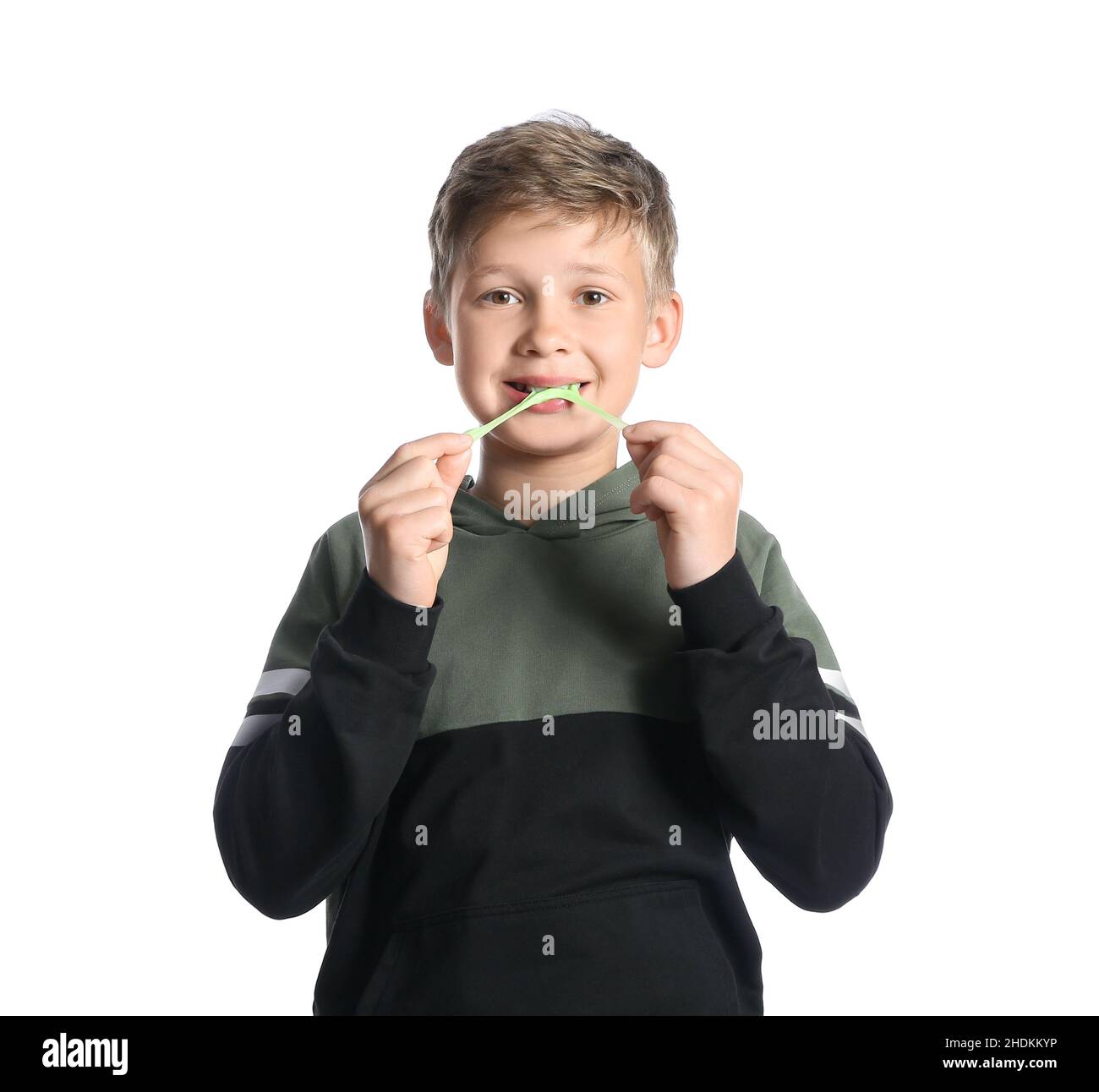 Little boy in hoodie chewing gum on white background Stock Photo - Alamy