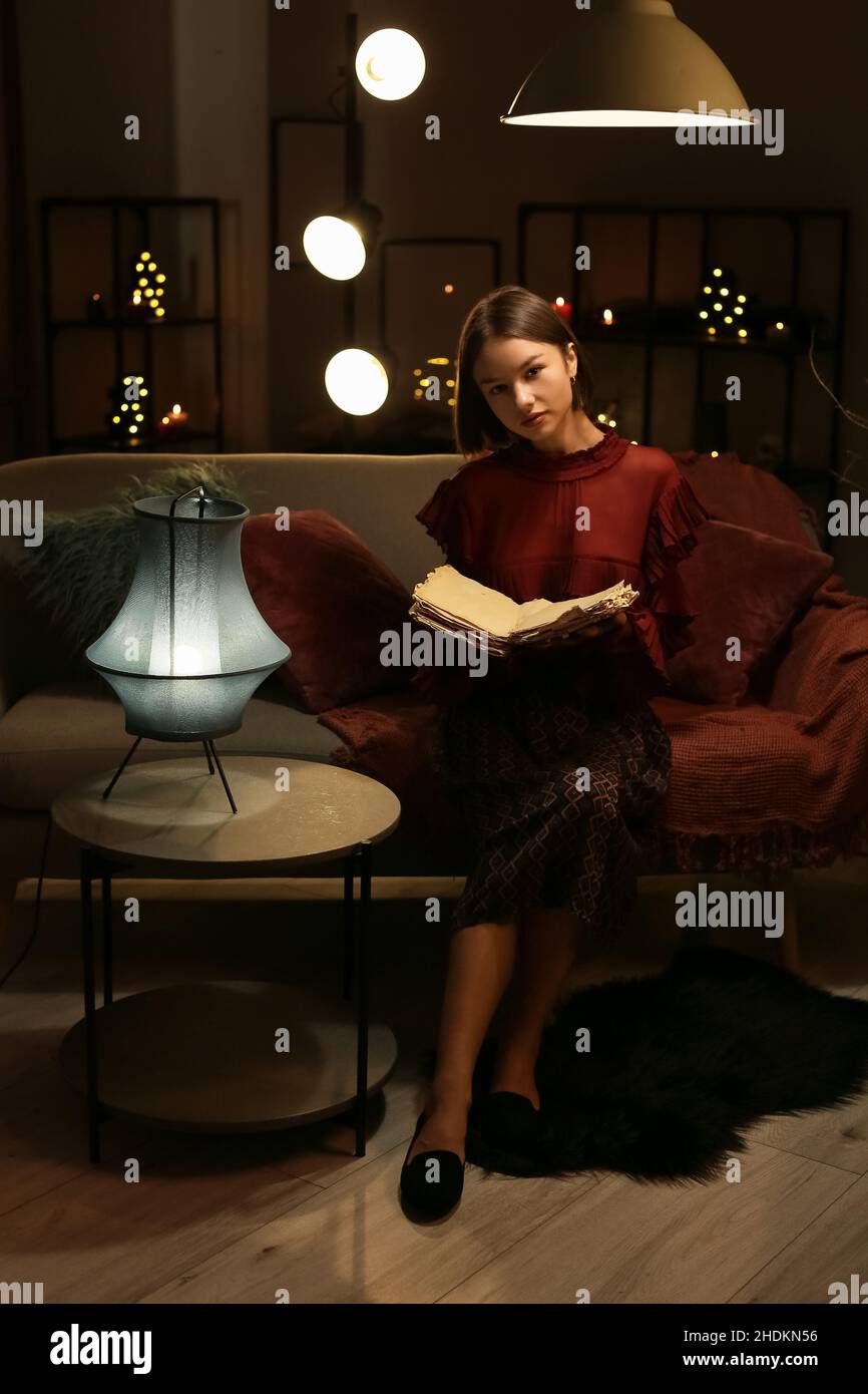 Beautiful woman reading old book at home Stock Photo - Alamy