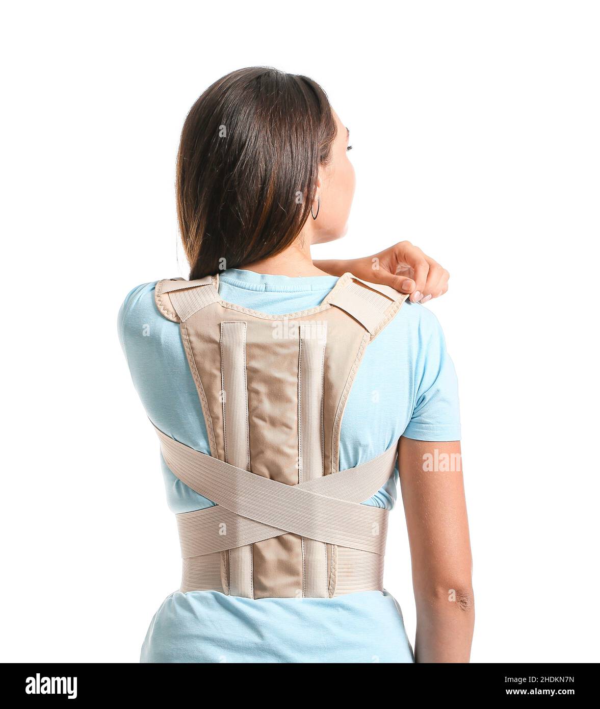 Young woman in back brace on white background Stock Photo - Alamy