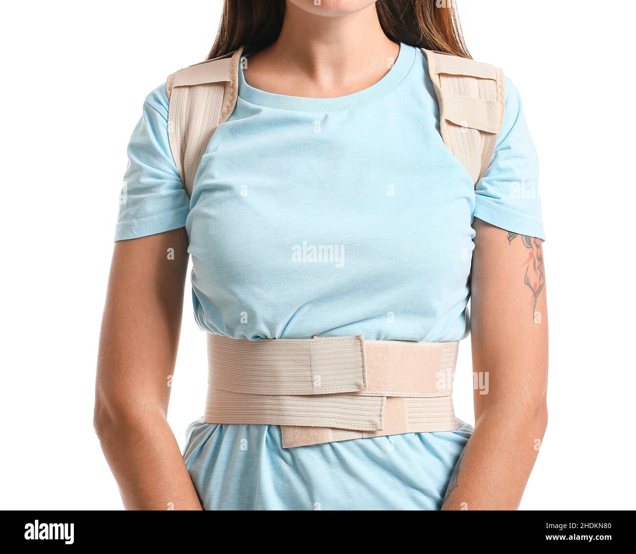 Young woman in back brace on white background Stock Photo - Alamy