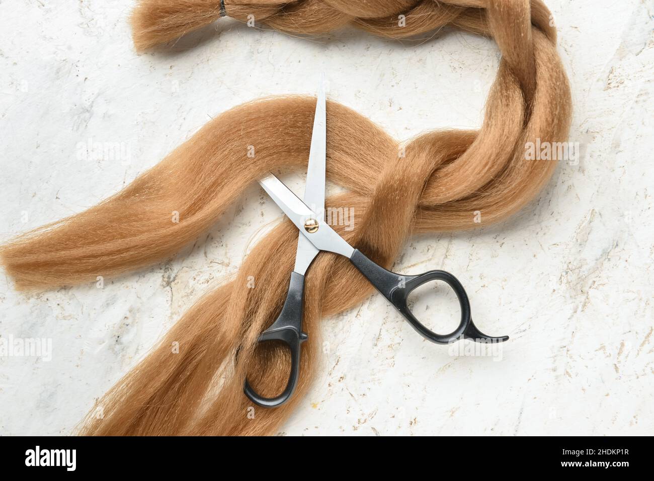 Red hair strand for donation with scissors on grunge background Stock ...