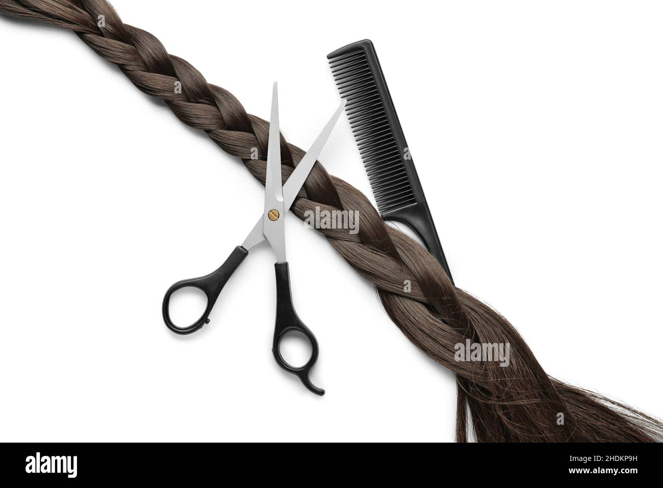 Braided brunette hair for donation with scissors on white background ...