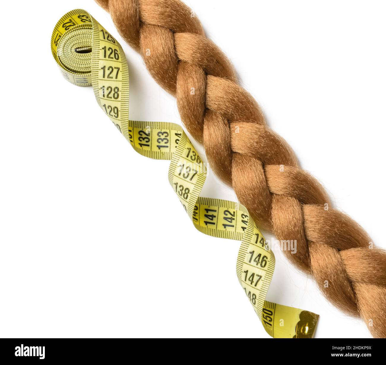 Braided red hair for donation with measuring tape on white background ...