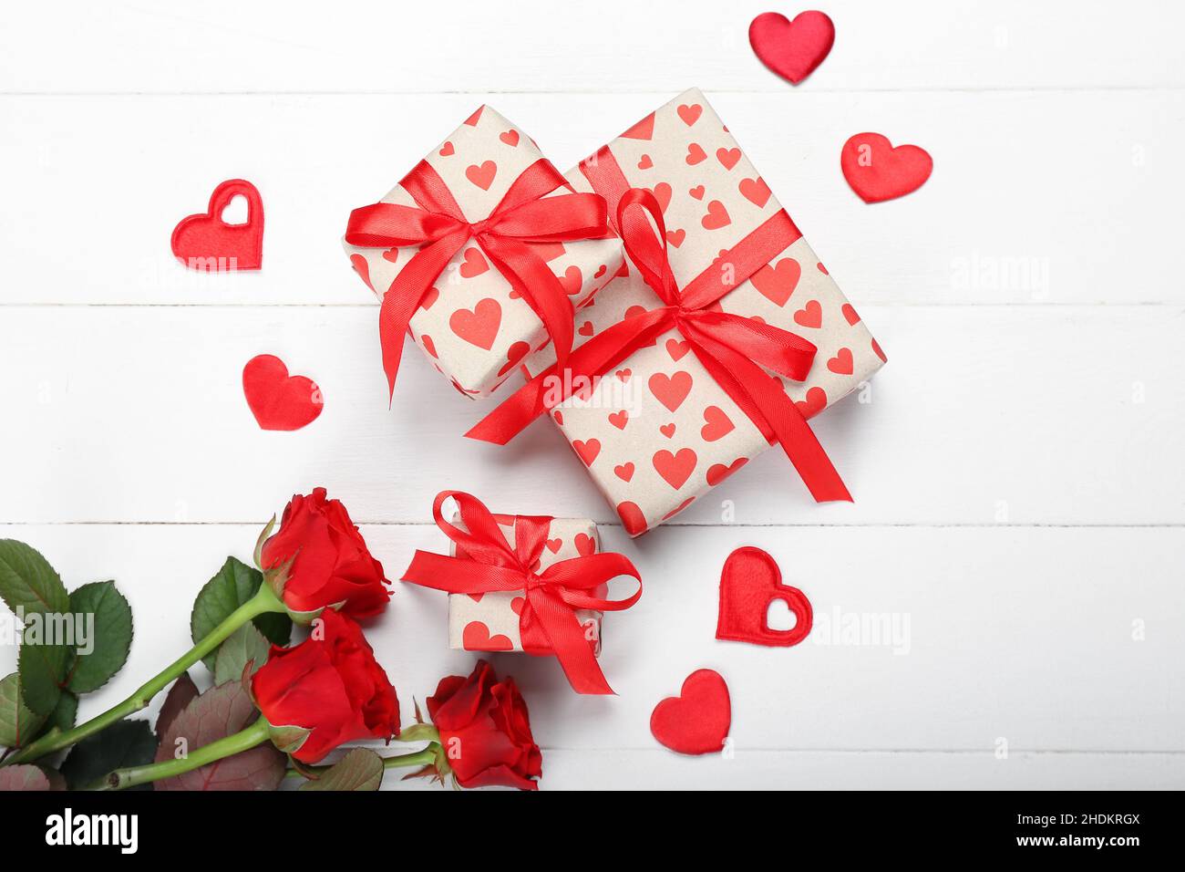 Beautiful roses and gift boxes for Valentine's Day on white wooden ...