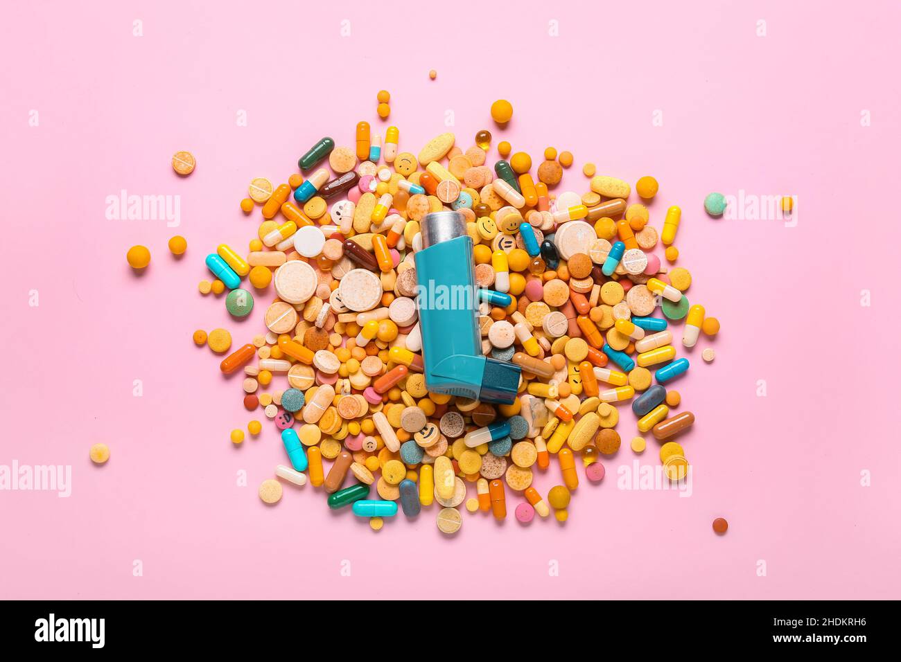 Asthma inhaler and different pills on pink background Stock Photo - Alamy