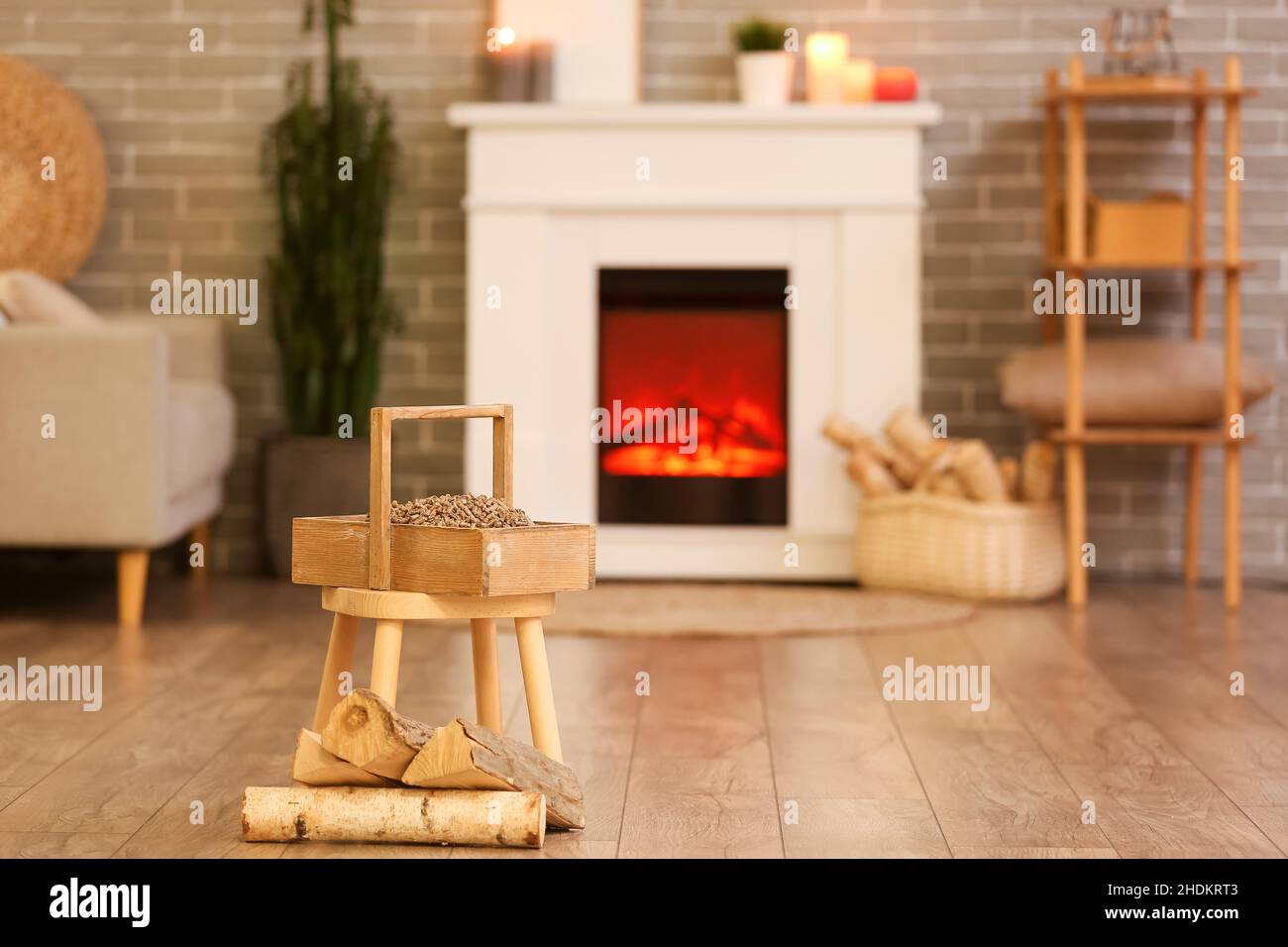Box with pellets, stool and woods in living room Stock Photo - Alamy
