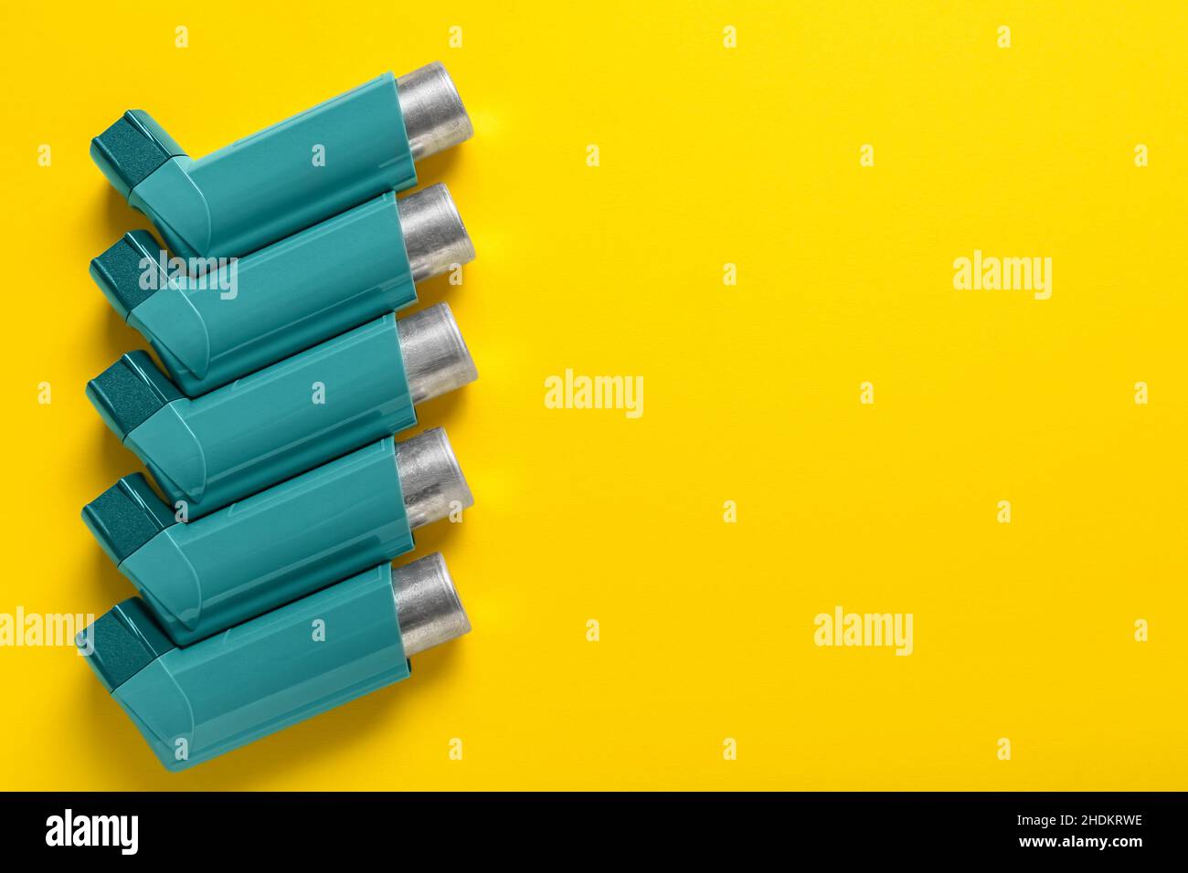 Asthma inhalers on yellow background Stock Photo - Alamy
