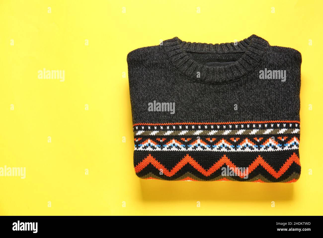 Dark sweater with stylish pattern on yellow background Stock Photo - Alamy