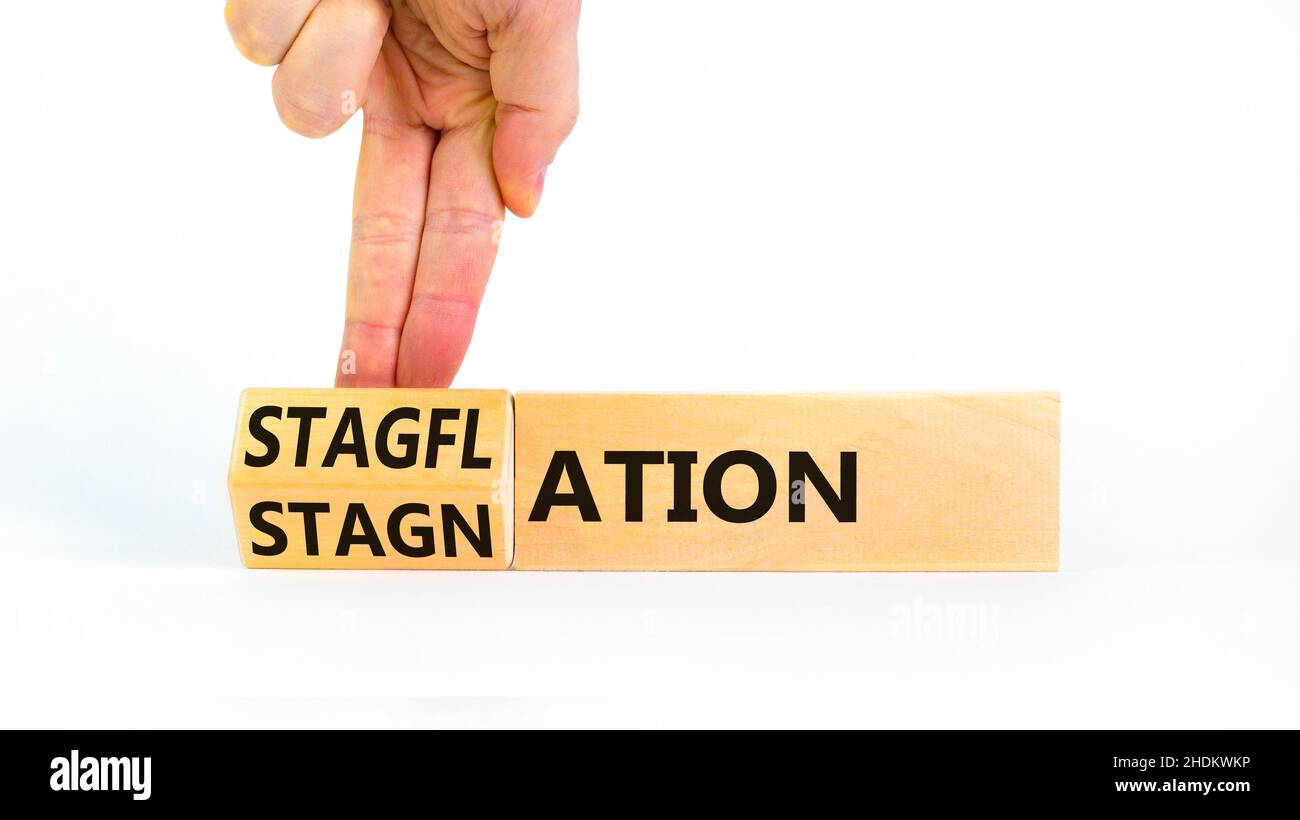 Stagflation or stagnation symbol. Businessman turns cubes, changes the ...
