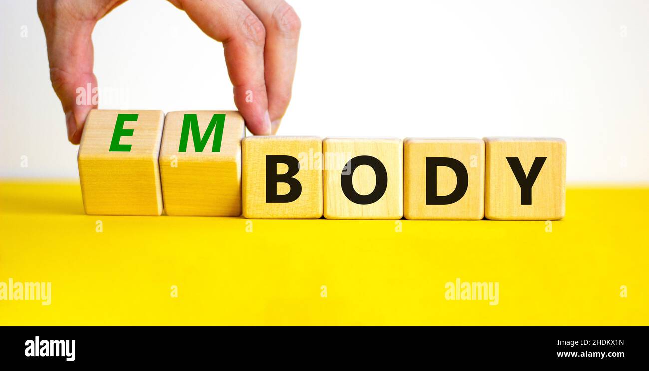 Body and embody symbol. Doctor turns wooden cubes and changes the ...