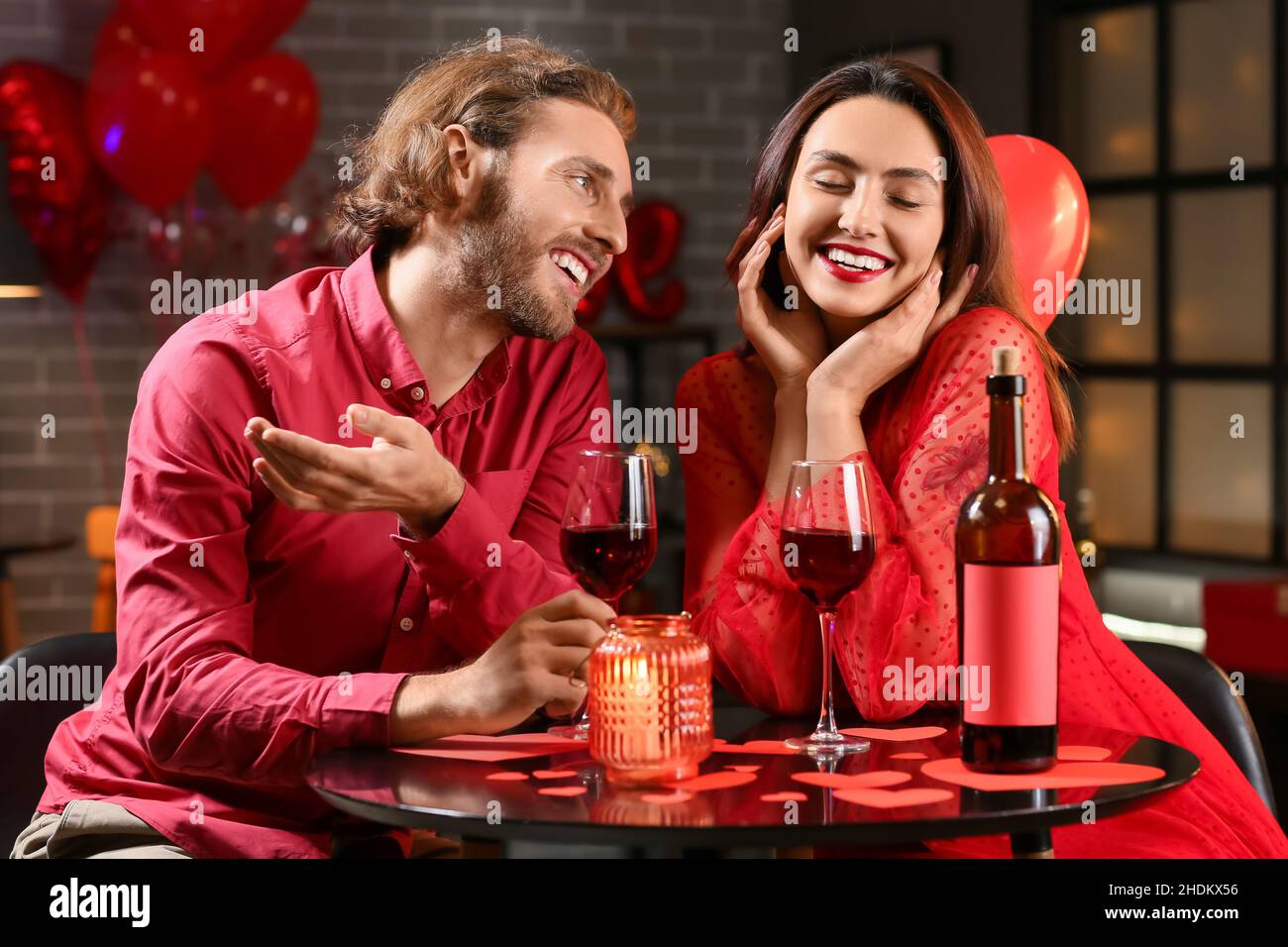 Happy young couple celebrating Valentine's Day in cafe Stock Photo - Alamy