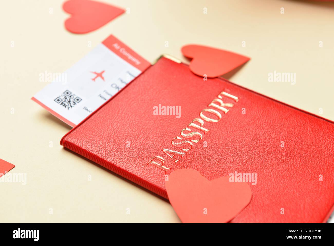Passport with ticket and paper hearts on beige background, closeup ...