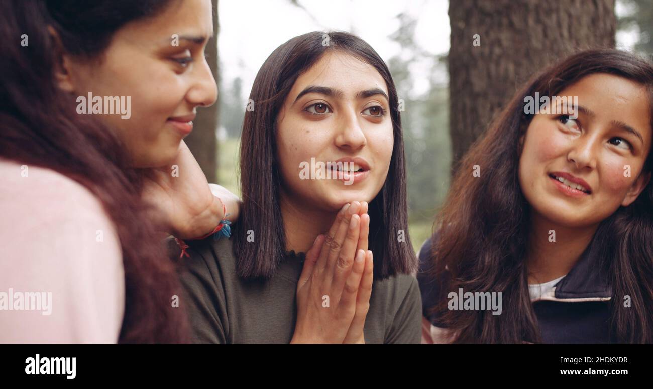 Group of young Indian female friends talking and laughing in a park ...