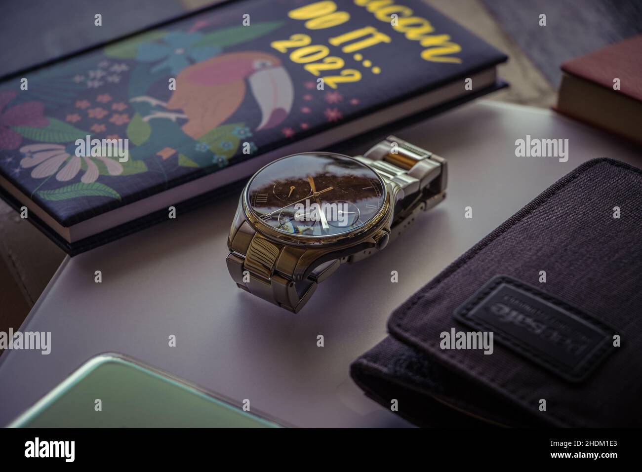 Watch and planner on table Stock Photo - Alamy