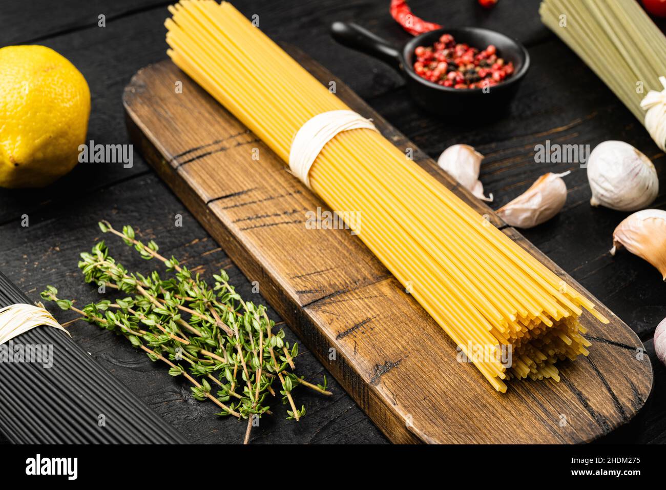 Dry colorful pasta spaghetti set, on black wooden table background ...