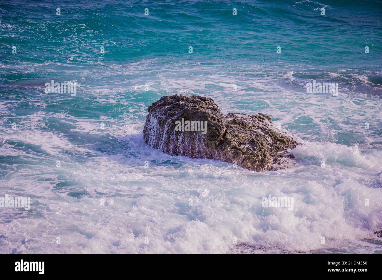 Ocean waves and rock Stock Photo - Alamy