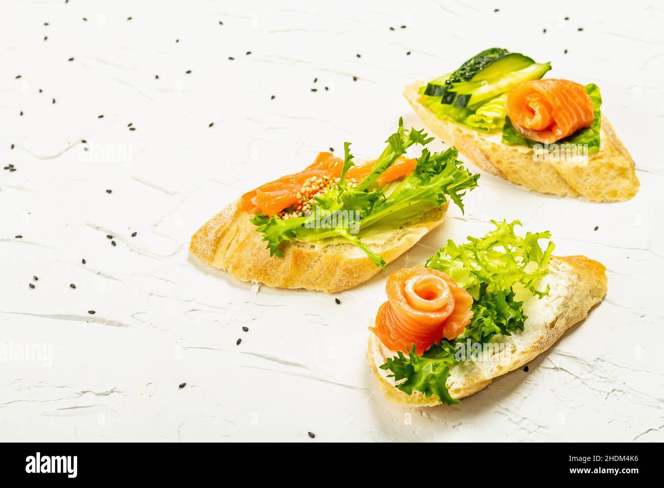 Open sandwiches with salted salmon, cream cheese, salad leaves and ...