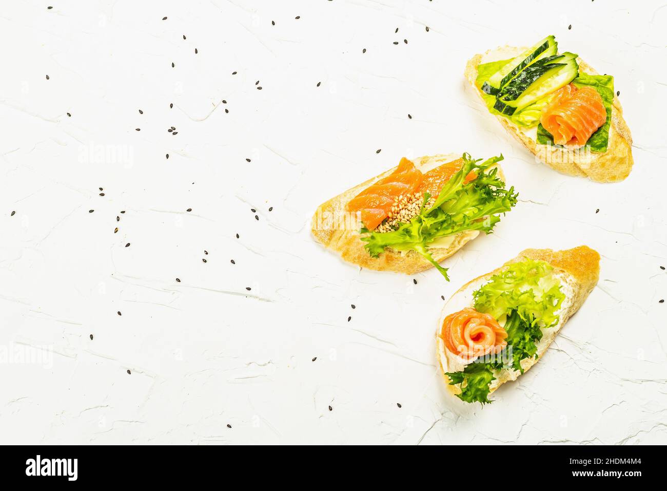 Open sandwiches with salted salmon, cream cheese, salad leaves and ...