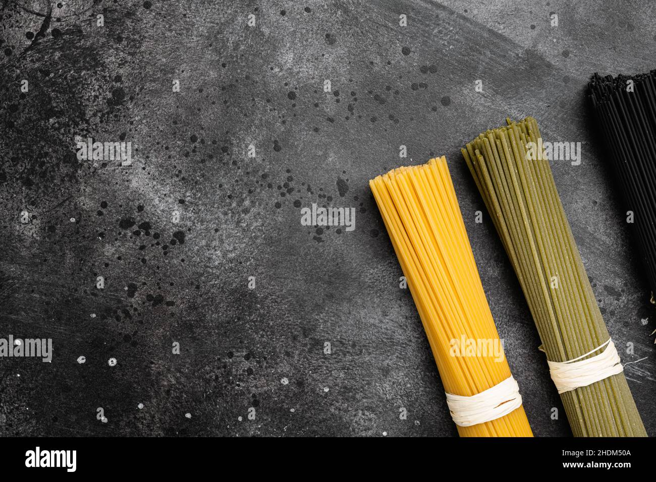 Multi colored pasta set, on black dark stone table background, top view ...