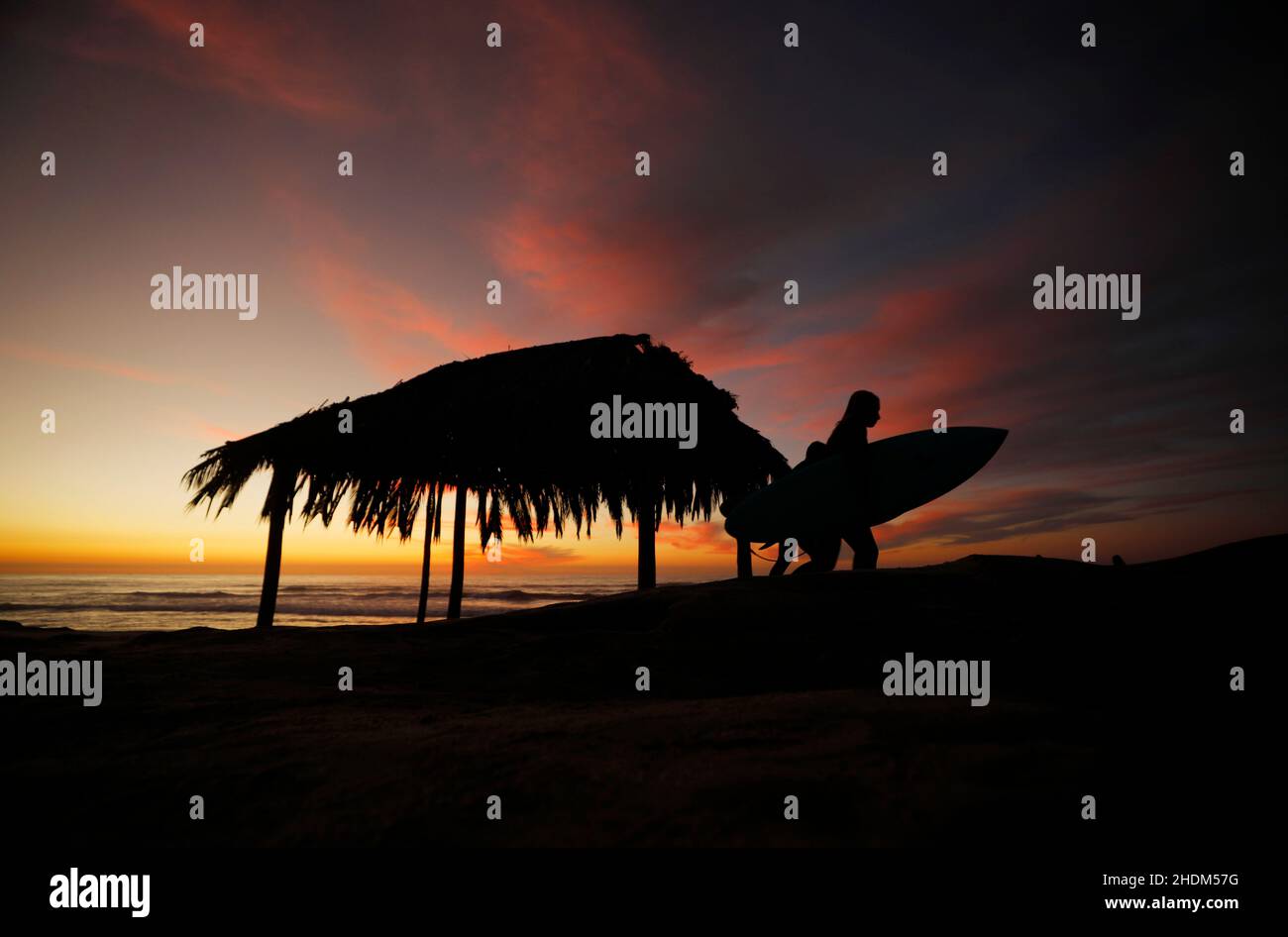 San Diego, California, USA. 5th Jan, 2022. As surfers walk by, the sun ...