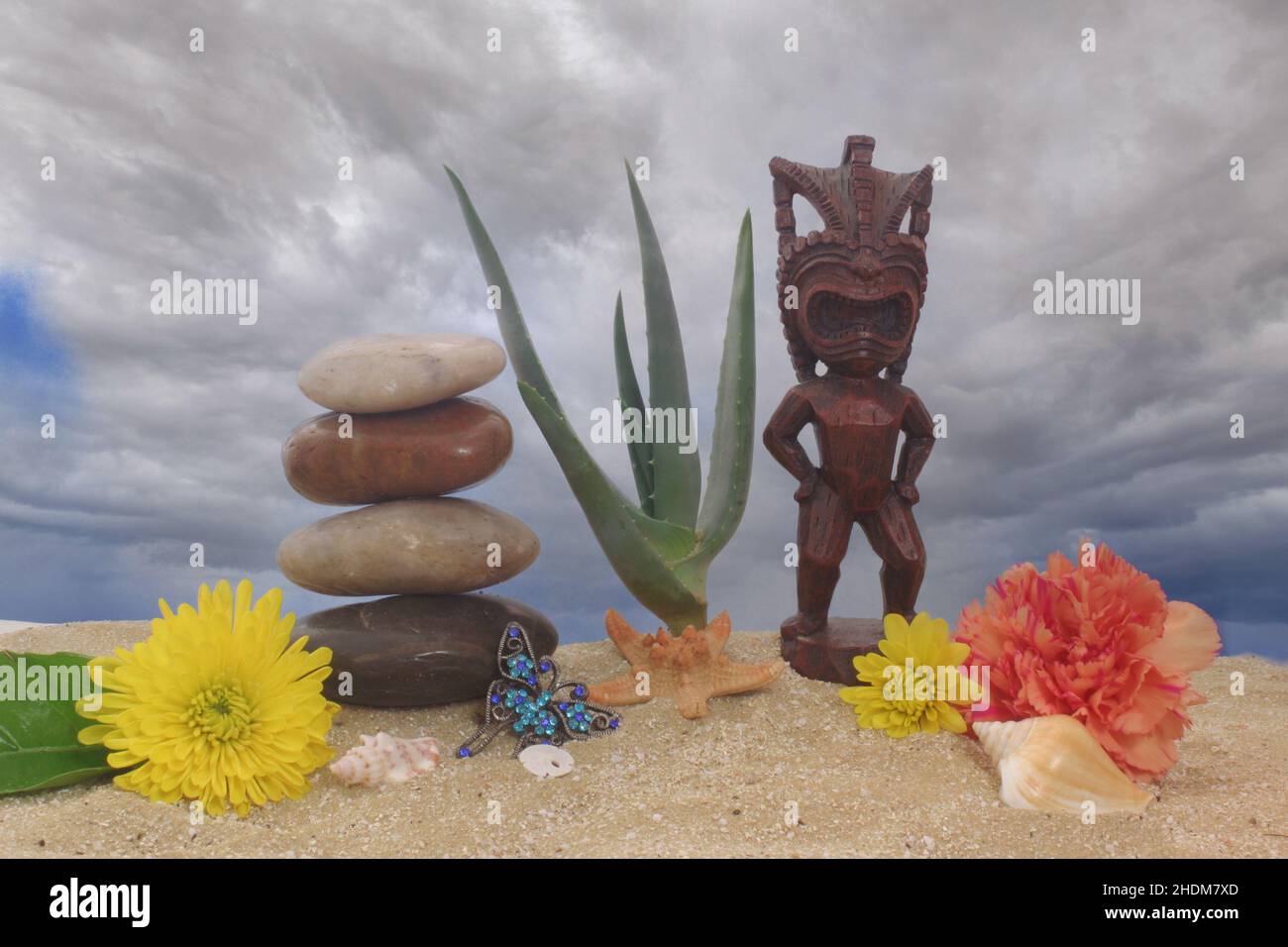Tiki Statue on Sand With Flowers and Sea Shells. Beach Scenery Stock ...